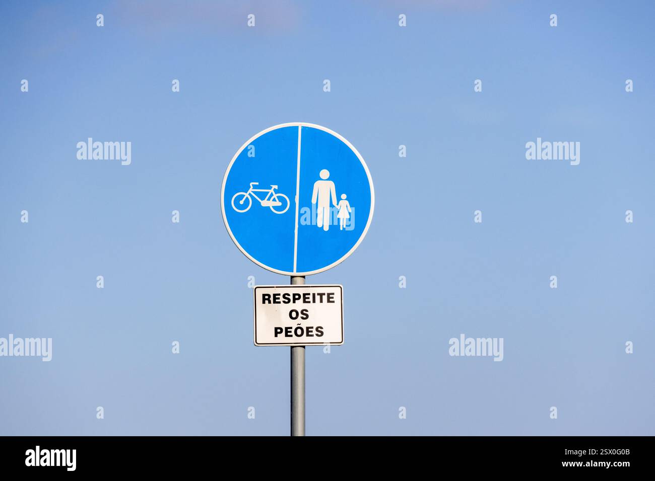 Circular blue road sign indicating pedestrian and bicycle lane ...