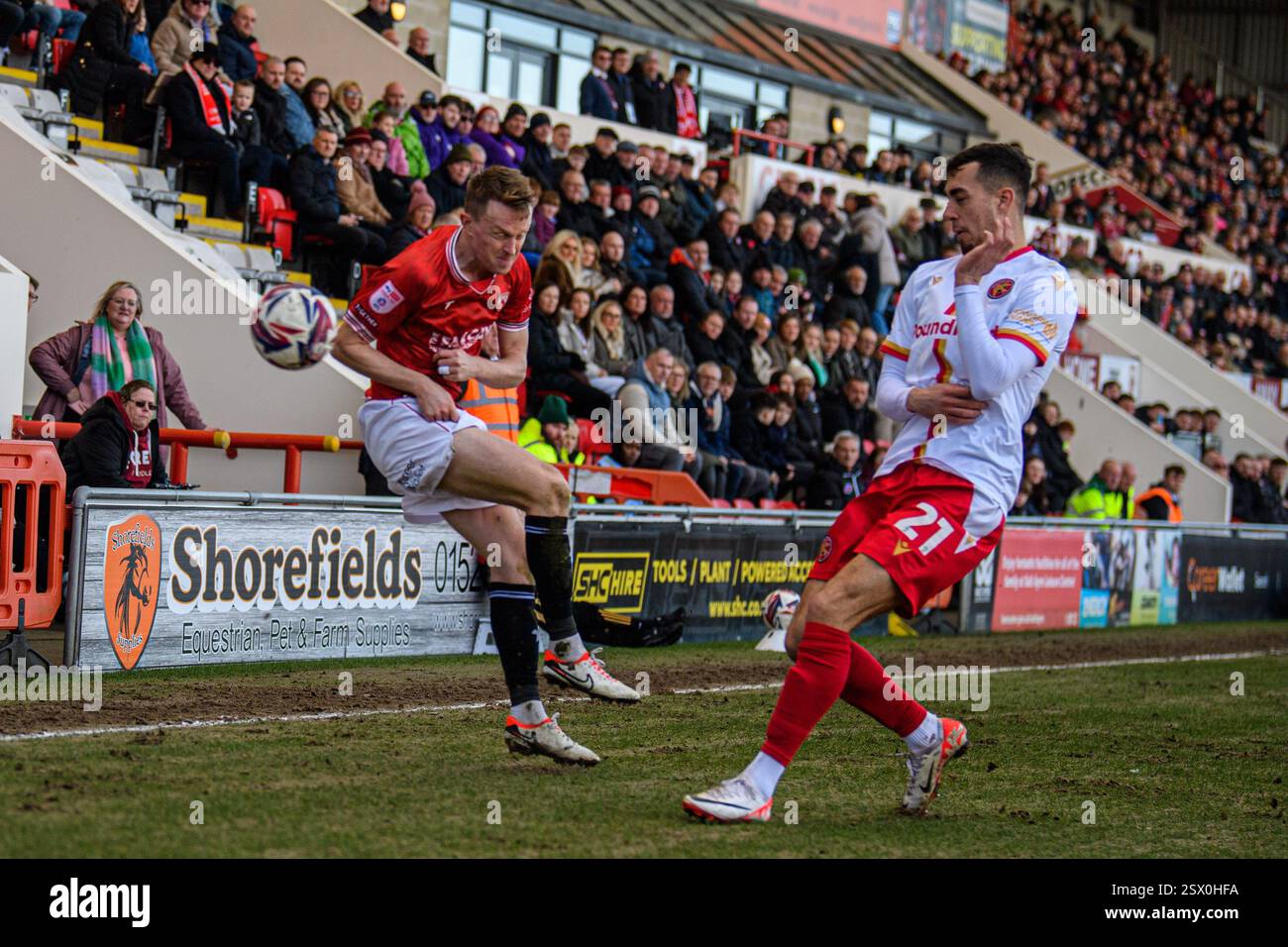 Morecambe FC's Luke Hendrie under pressure from Taylor Allen of Walsall ...