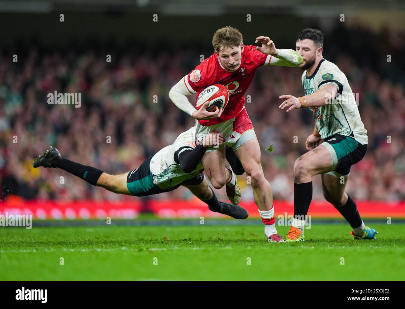 Wales' Ellis Mee is tackled by Ireland's Sam Prendergast during the Guinness Men's Six Nations ...
