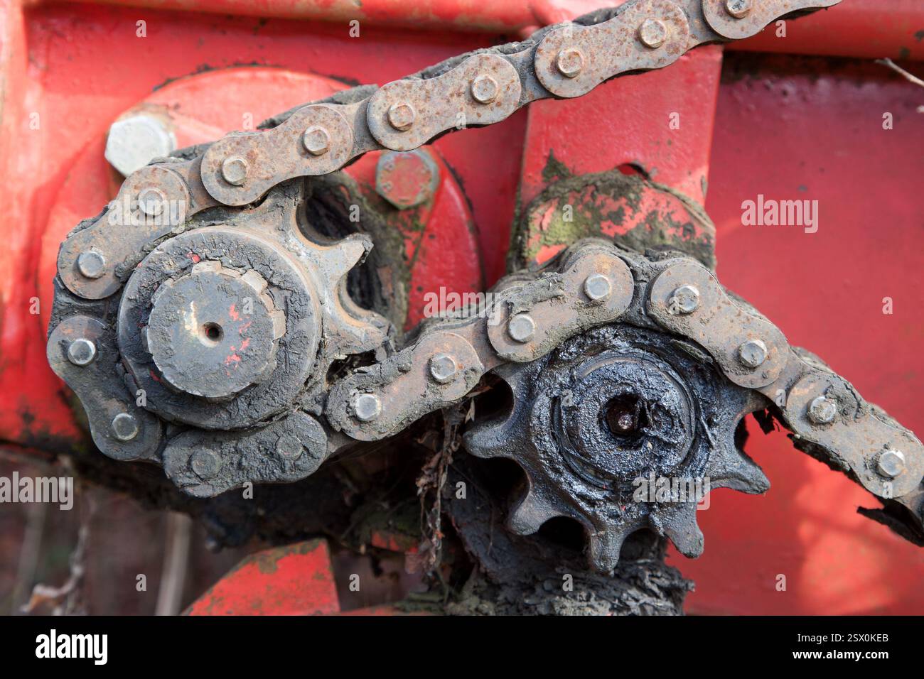 Oiled, dirty gears of a chain drive, old black grease and grime ...