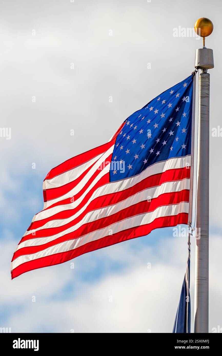 American flag waving with clouds in the background, vrtical Stock Photo ...