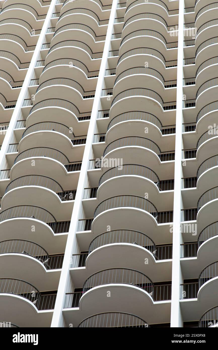 Building with many balconies and a lot of windows. The balconies are white and the building is ...