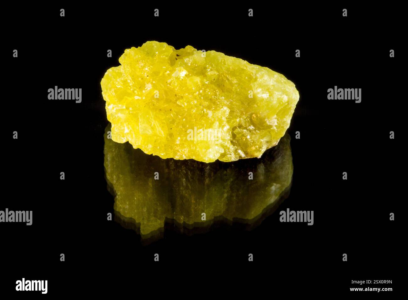 Yellow rock is on a black background. It is a piece of quartz. The rock ...