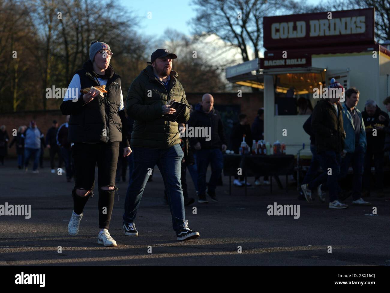 Fans arrive outside the ground before the Premier League match at Villa ...
