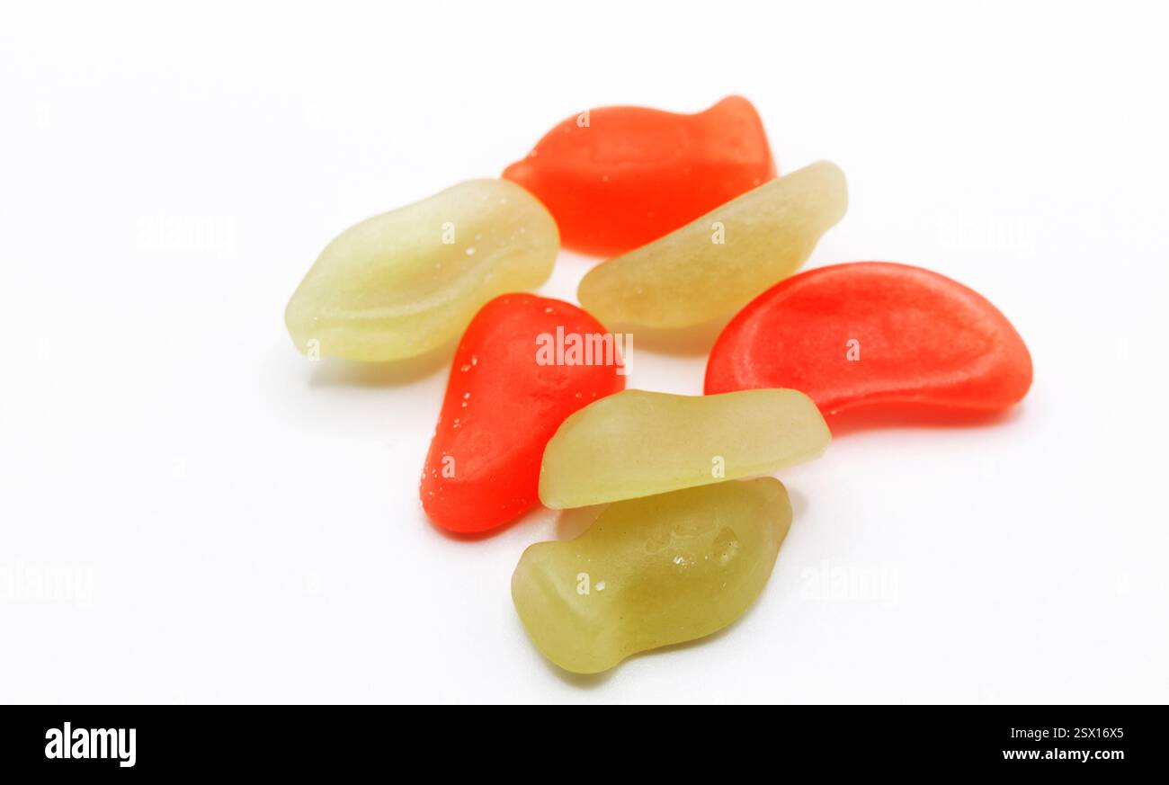 A collection of red and yellow fruit-shaped jelly candies Stock Photo ...