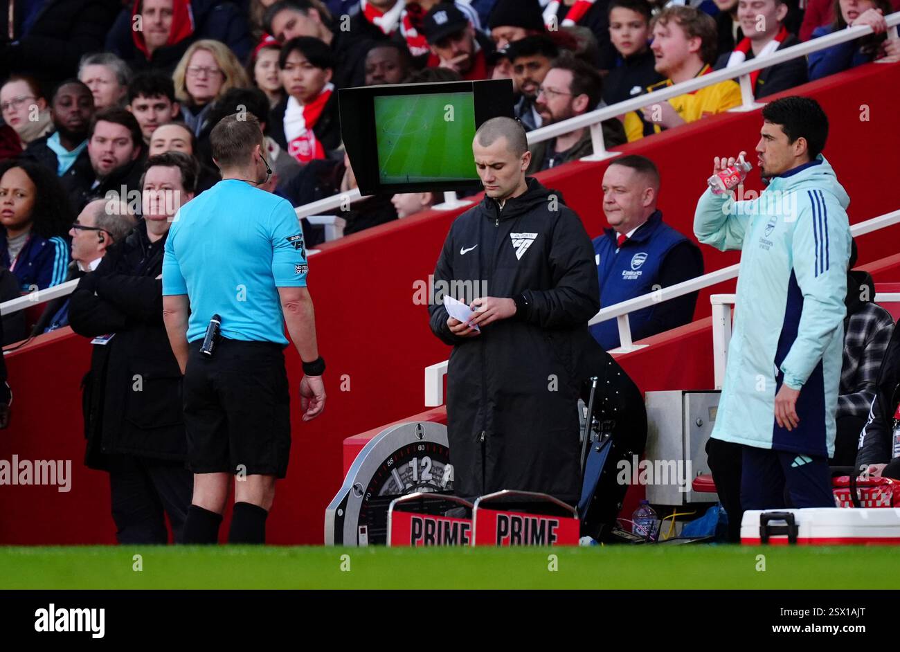 Referee Craig Pawson reviews the VAR monitor, which resulted in the ...