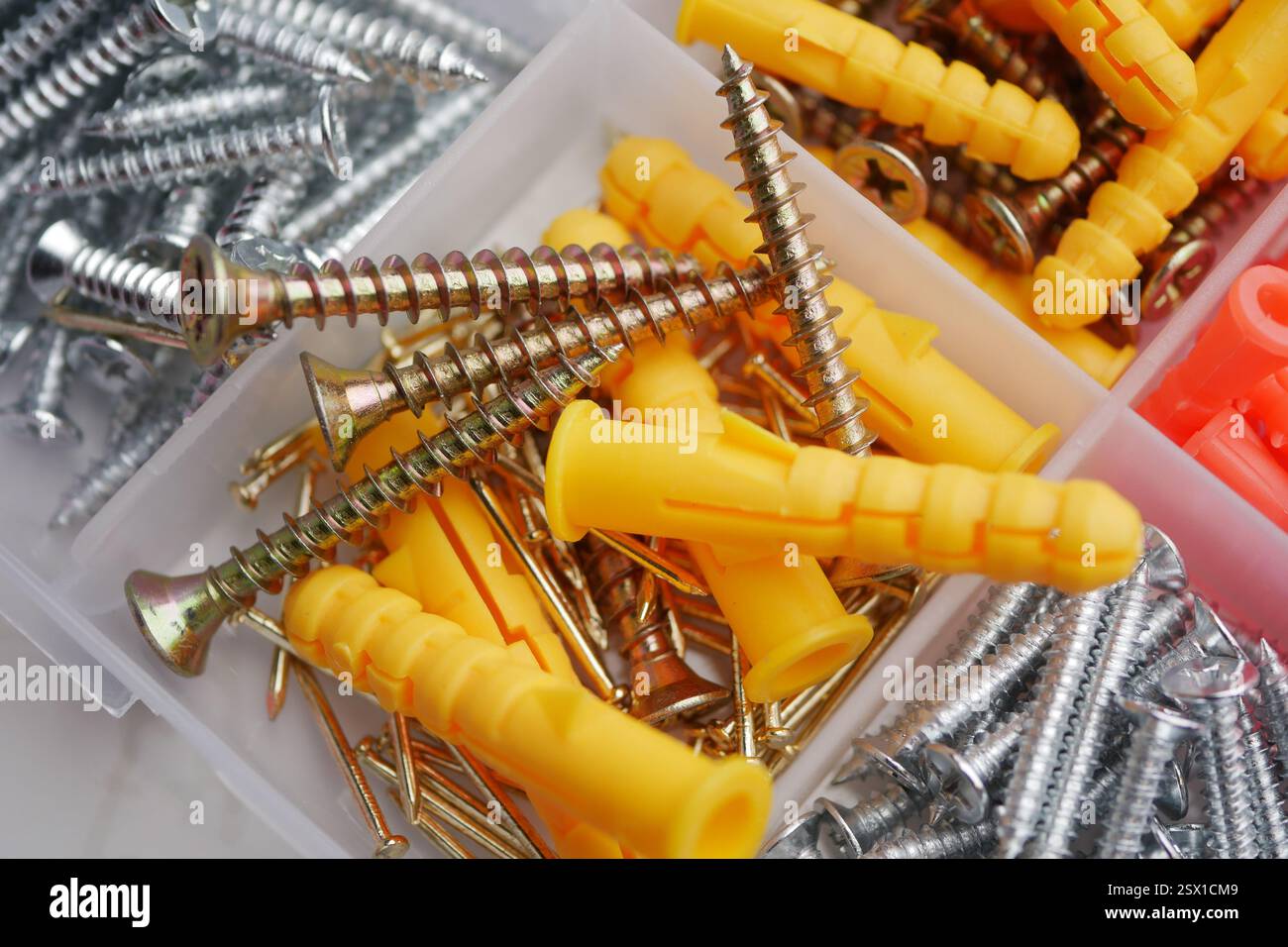 Colored screws and anchors organized in a storage container Stock Photo ...