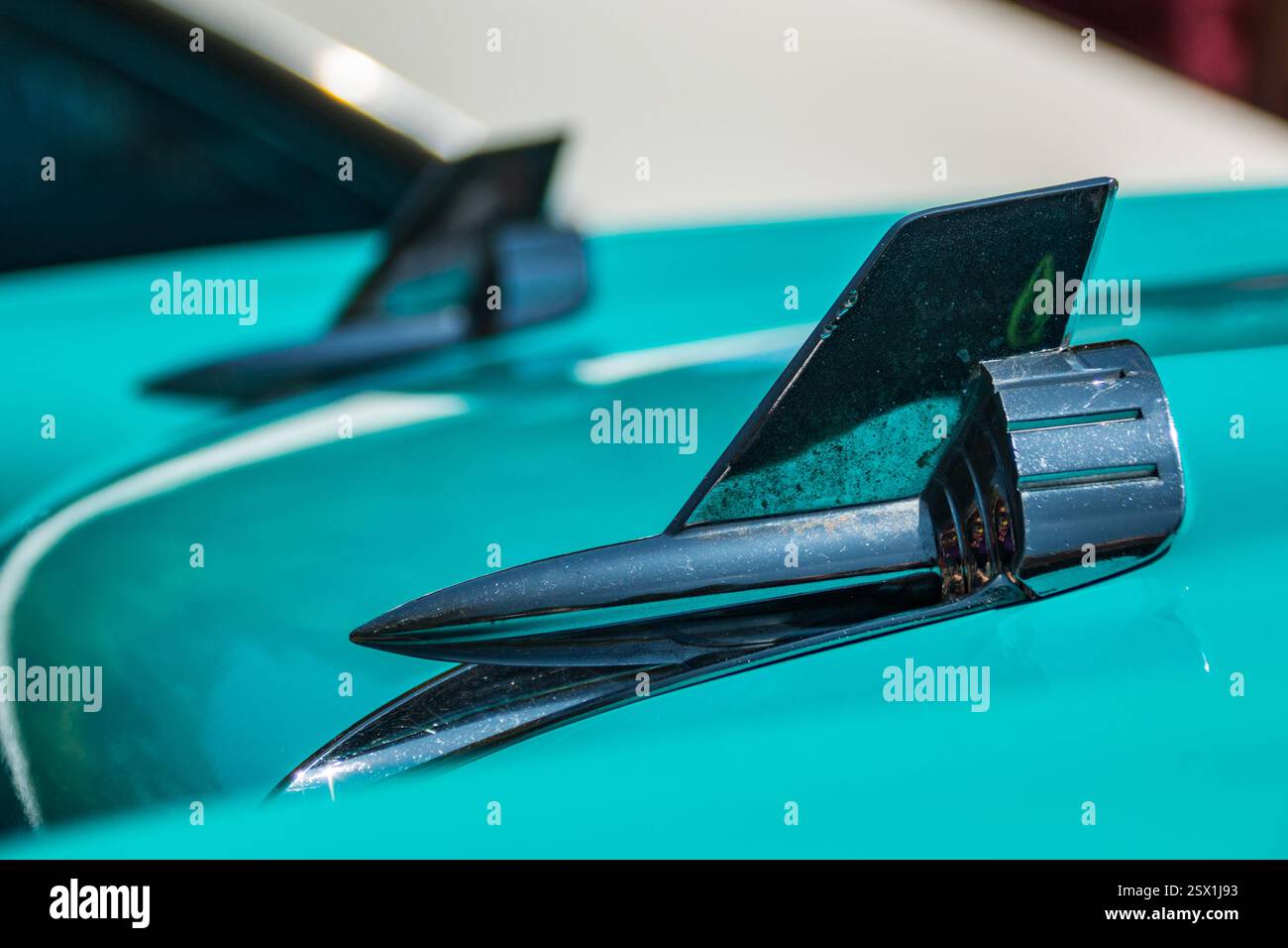 Two chrome rockets on the hood of a classic 1957 Chevrolet automobile ...