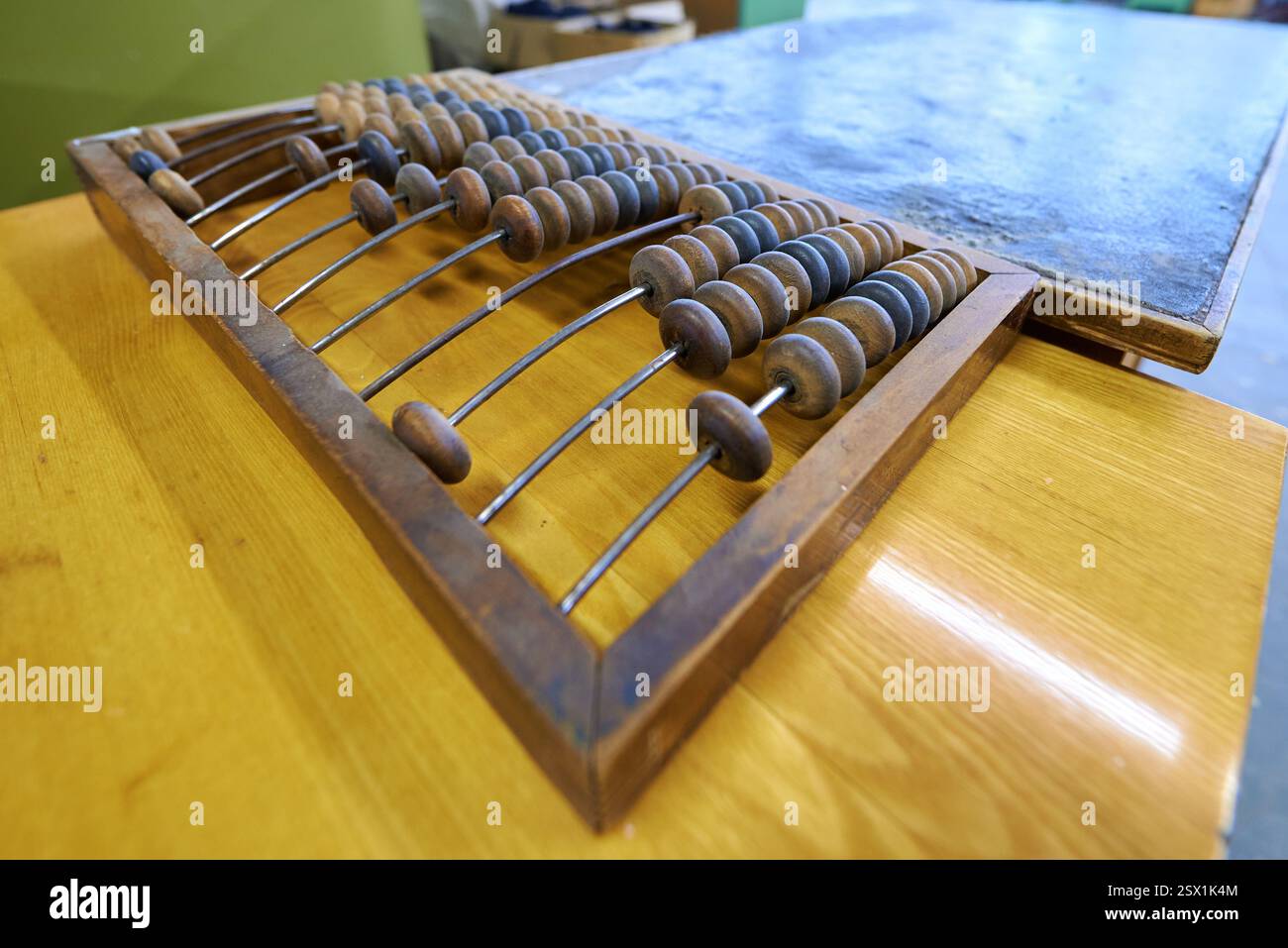 Mastering calculations with a traditional accounting abacus on a ...
