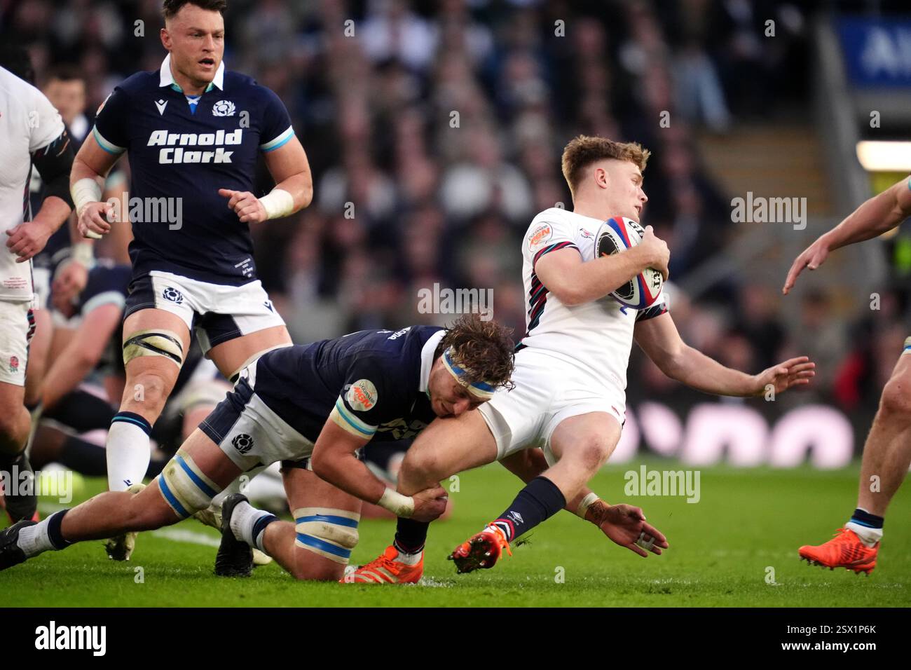 London, England. 22nd February, 2025. England's Fin Smith is tackled by ...