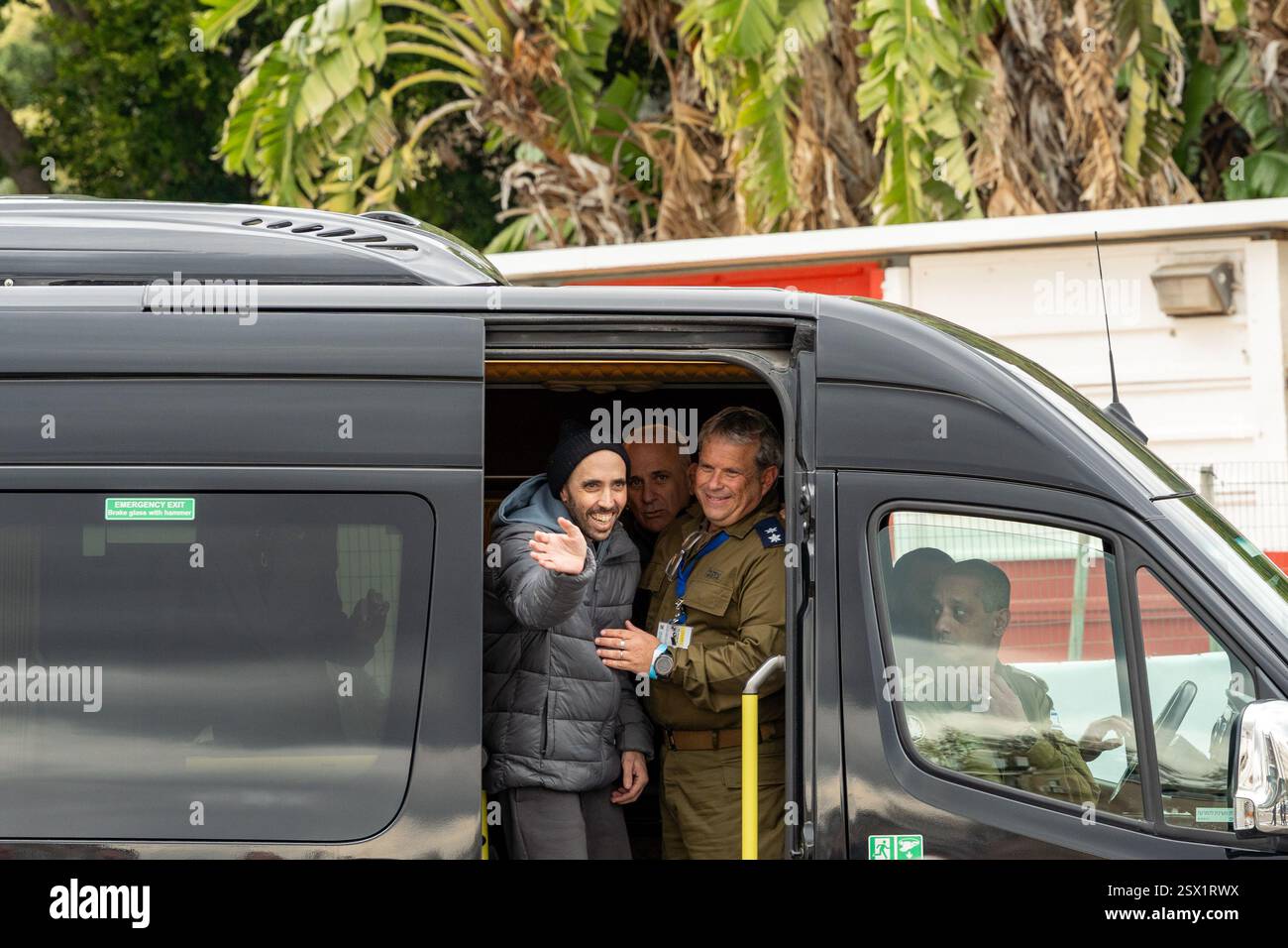 Returned hostage Tal Shoham waves to his family, friends and supporters ...