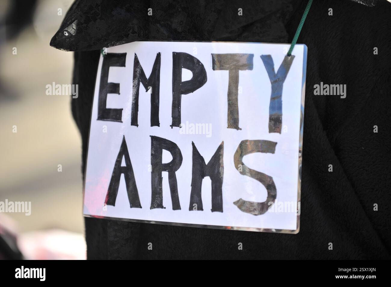 Glasgow, UK. 22nd Feb, 2025 - A protester is seen wearing a placard ...