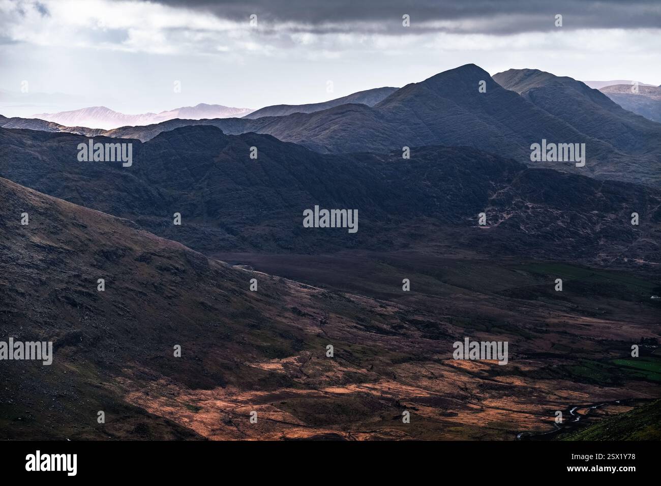 Majestic mountain landscape with soft light casting shadows over rugged ...