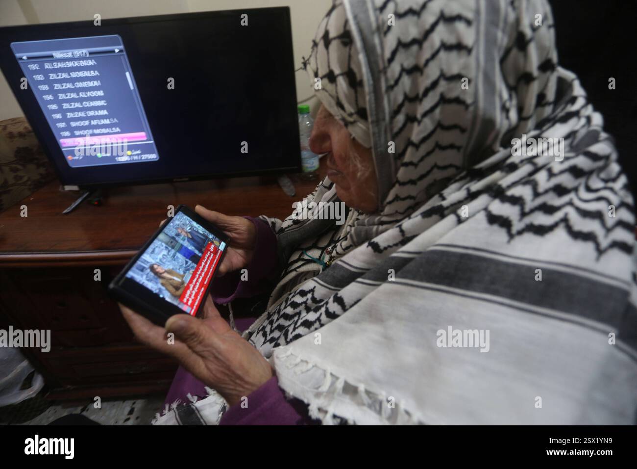 Palestinian Zahdia Khadisha 90 years old watches television to ...