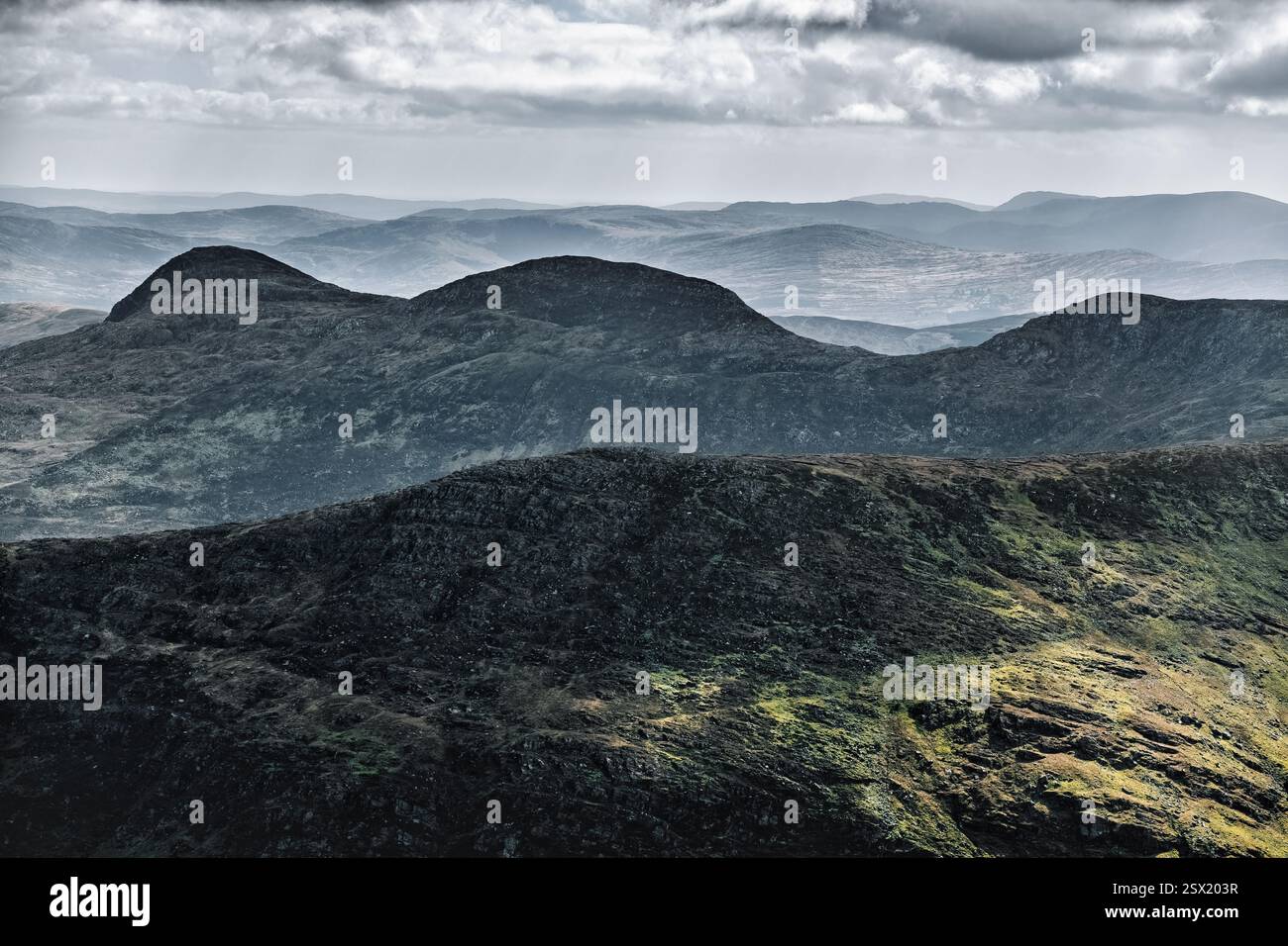 A landscape photograph of a mountain range. The mountains are ...