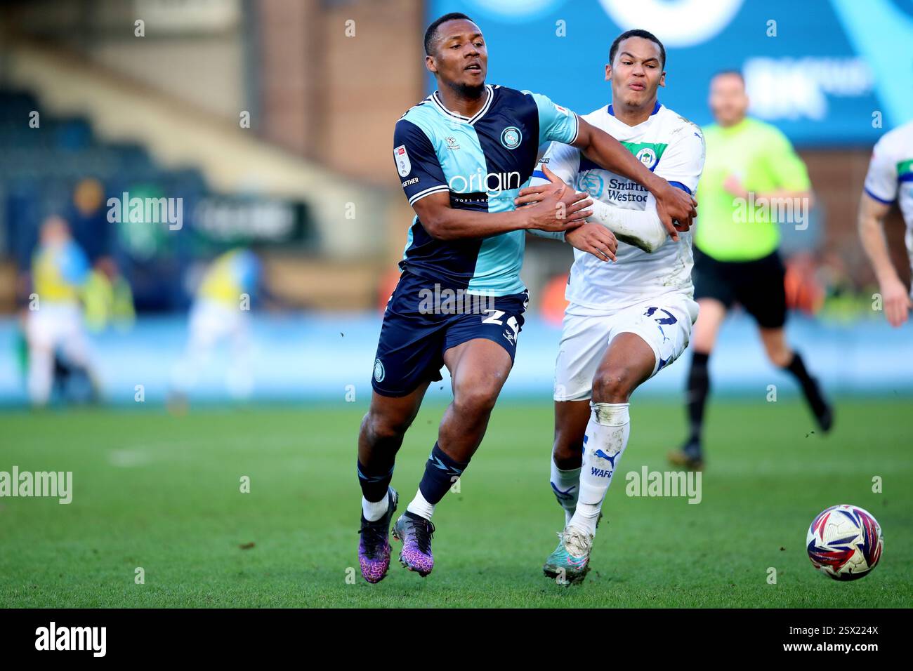 Wycombe Wanderers' Richard Kone battles for the ball against Wigan ...