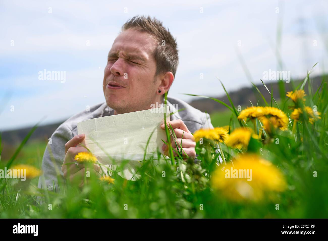 Bavaria, Germany - March 31, 2024: A man holds a handkerchief in front ...