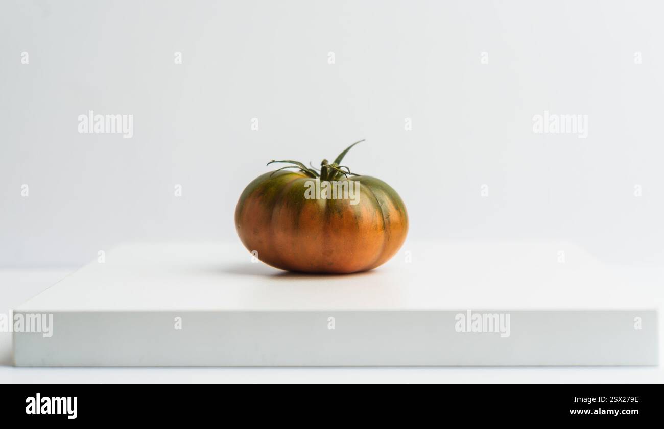 Fresh raf tomato displayed on a clean white surface, showcasing its ...