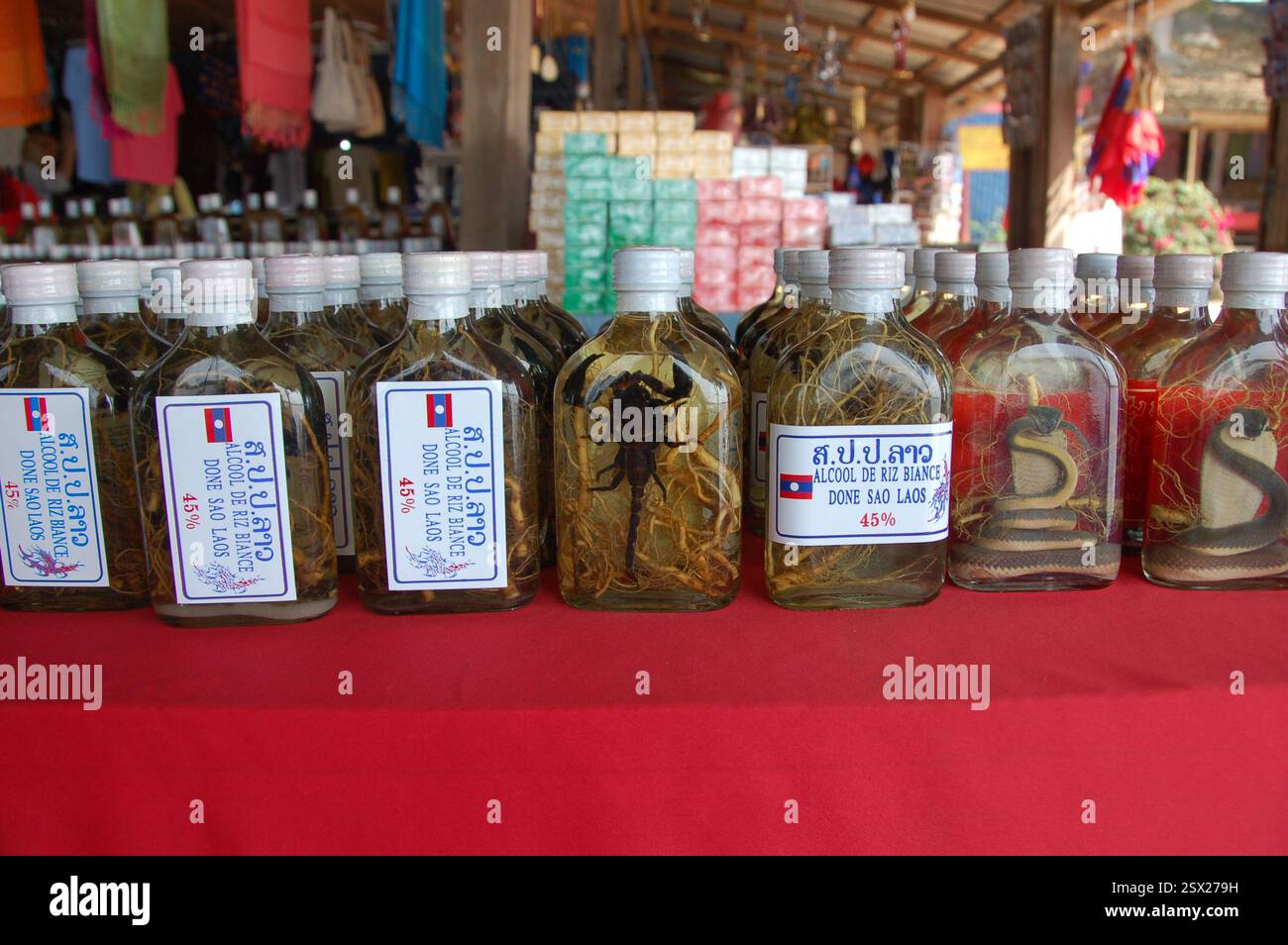 Small glass bottles of Lao rice liquor containing scorpions or snakes ...