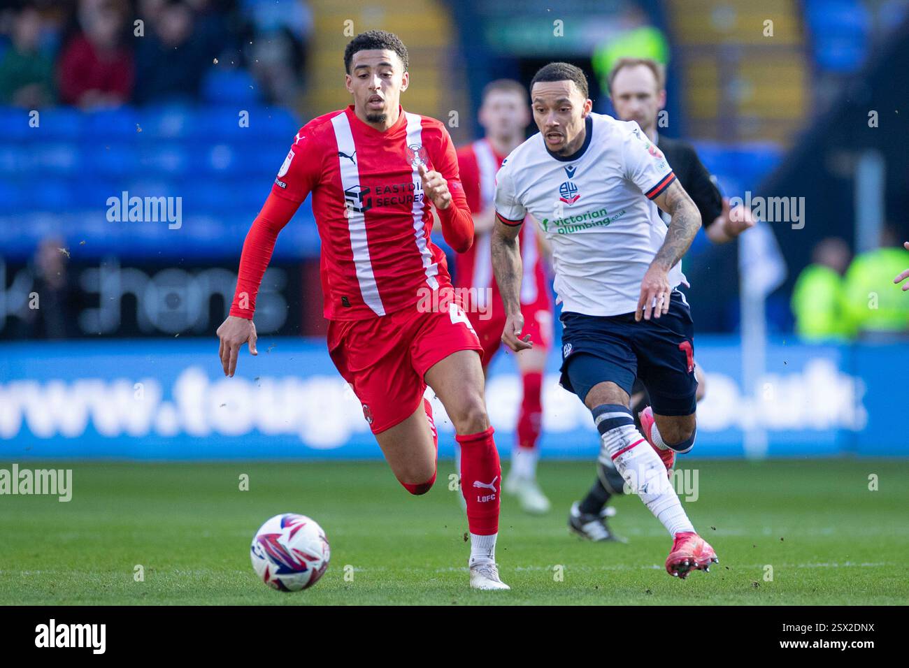 Josh Dacres-Cogley #12 of Bolton Wanderers F.C.tackled by the opponent ...
