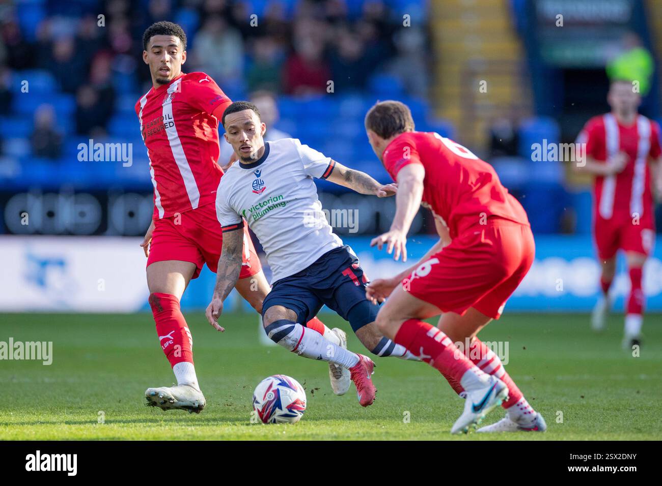 Josh Dacres-Cogley #12 of Bolton Wanderers F.C.tackled by the opponent ...