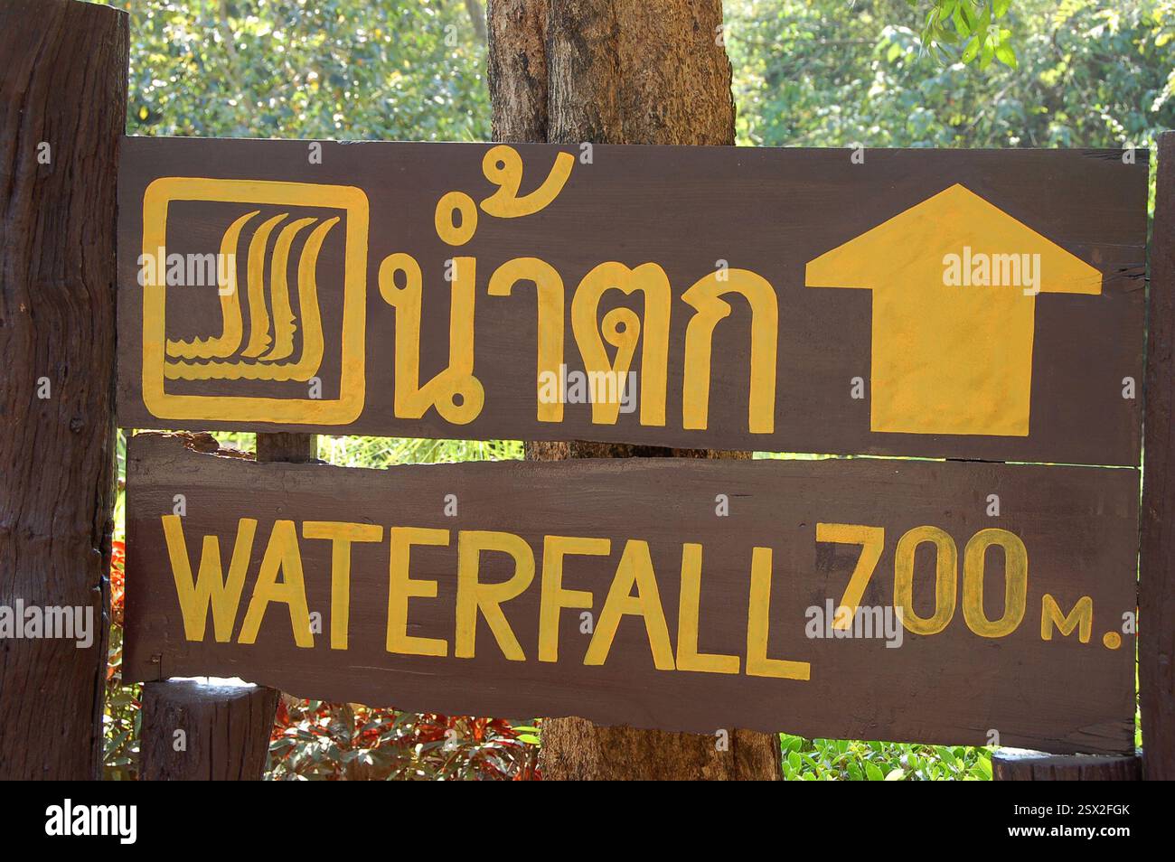 Wooden sign at Erawan National Park, Thailand, displaying both English ...