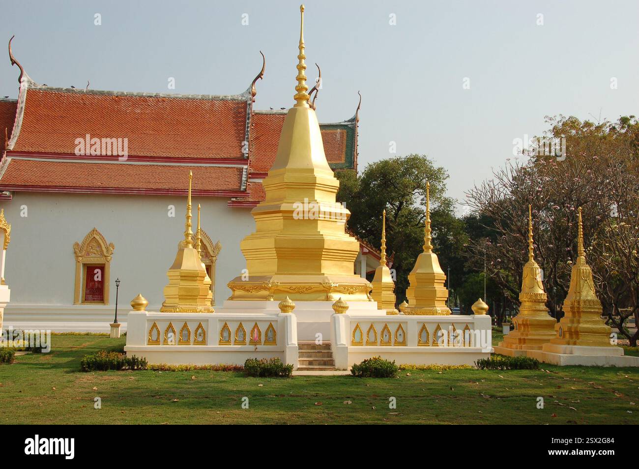 Golden chedis (stupas) at Wat Thawonwararam temple in Kanchanaburi ...