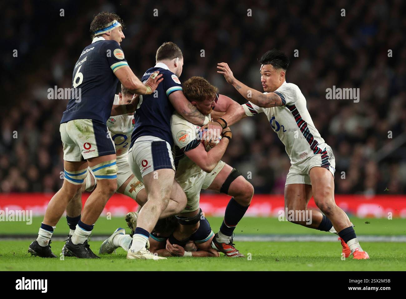 England's Ollie Chessum is tackled by Scotland's Ewan Ashman during the ...