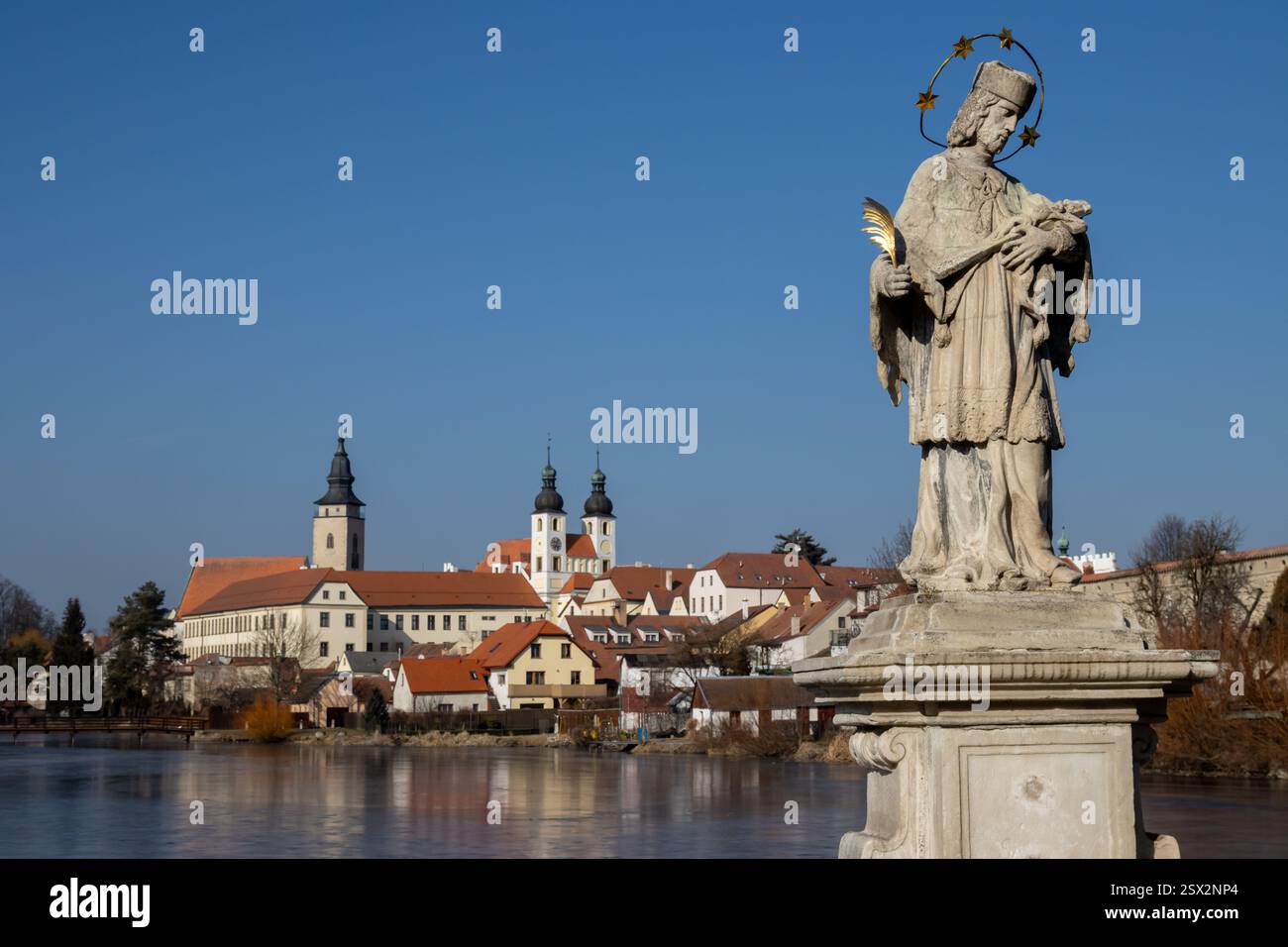 Historical statue of a saint Jan Nepomucky on a dam bridge beside ...