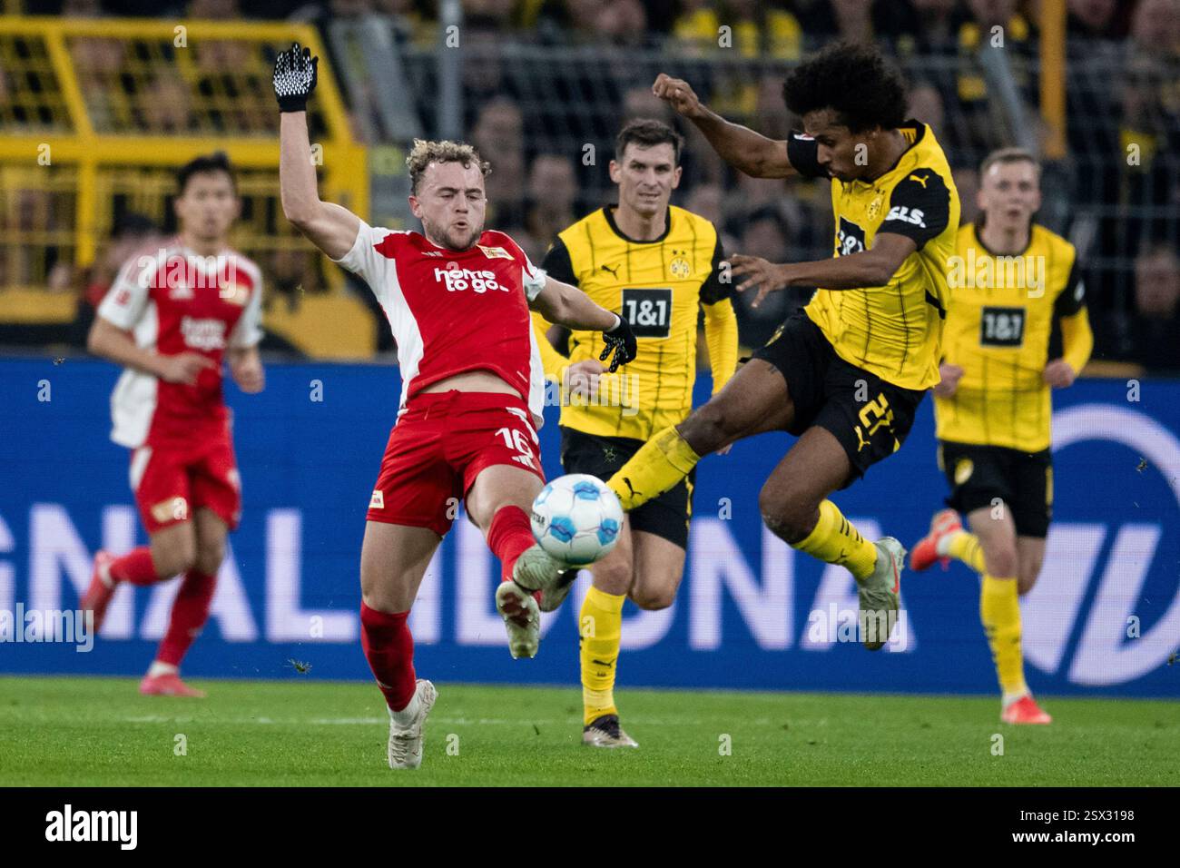 Union Berlin's Benedict Hollerbach, left, and Dortmund's Karim Adeyemi ...