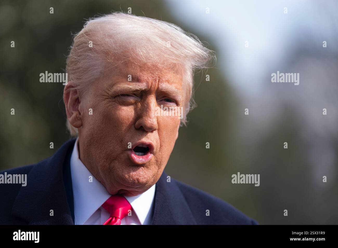 President Donald Trump speaks to reporters before leaving the White ...