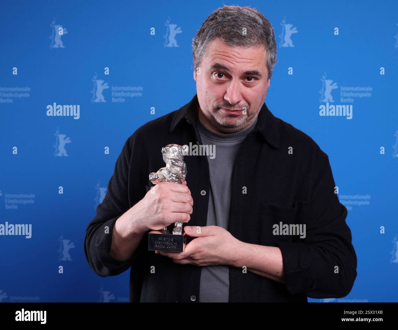 Romanian director Radu Jude poses with the Silver Bear for Best ...