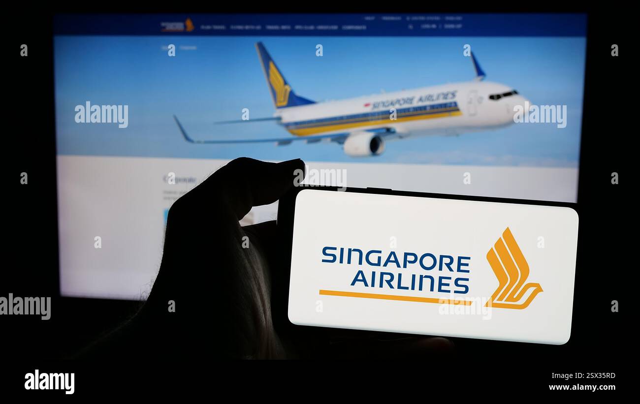 In this photo illustration, a mobile phone with the logo of airline ...