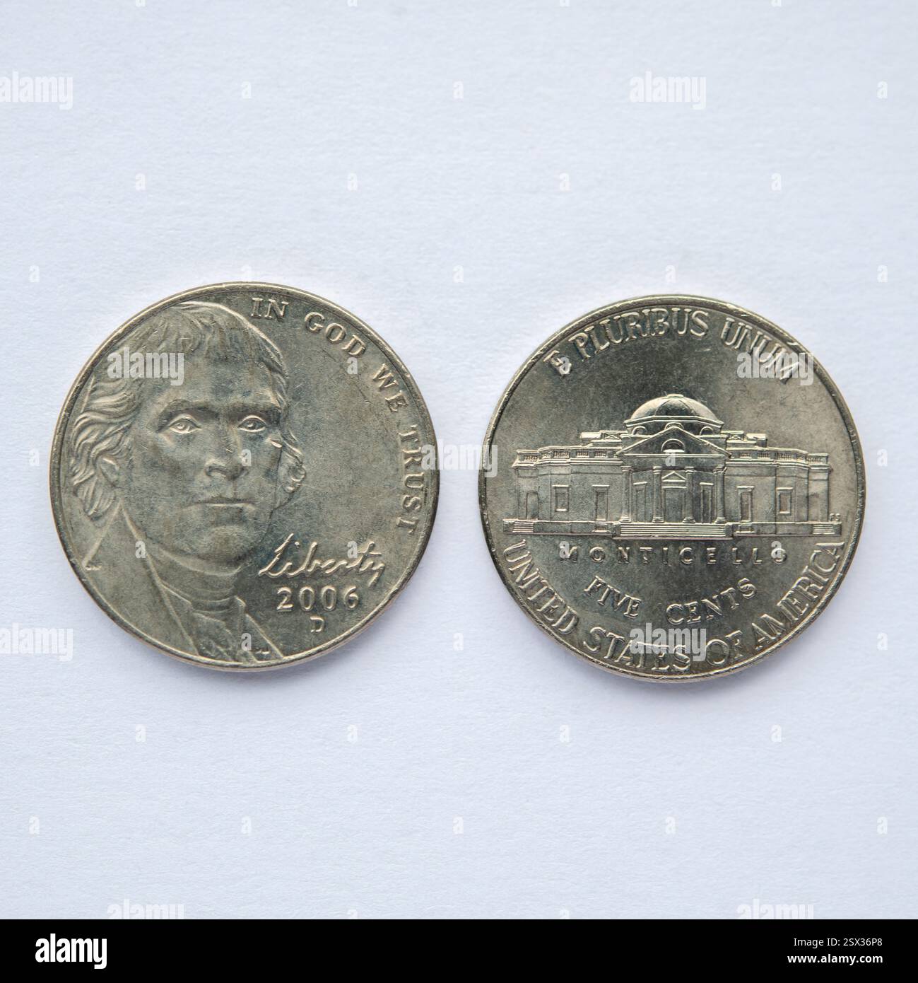 Still life of the front and reverse sides of an American five cent coin ...