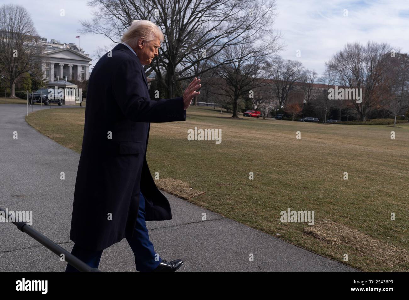 President Donald Trump waves to reporters as he leaves the White House ...