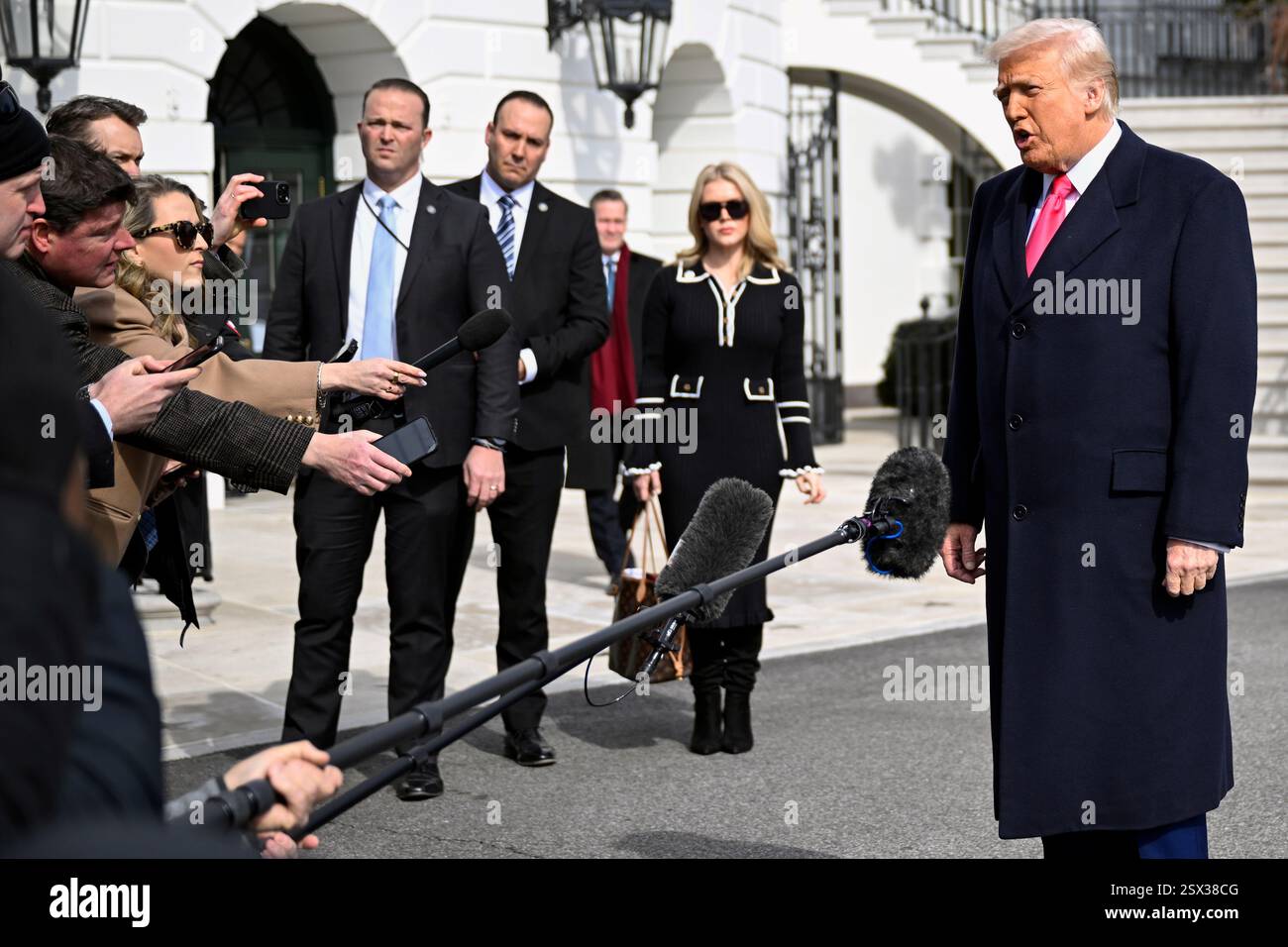 President Donald Trump speaks to reporters before departing the White ...