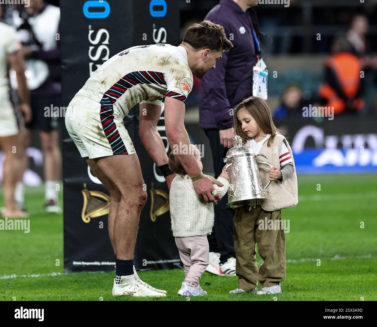 Elliot Daly of England holds the Calcutta Cup with his children during ...