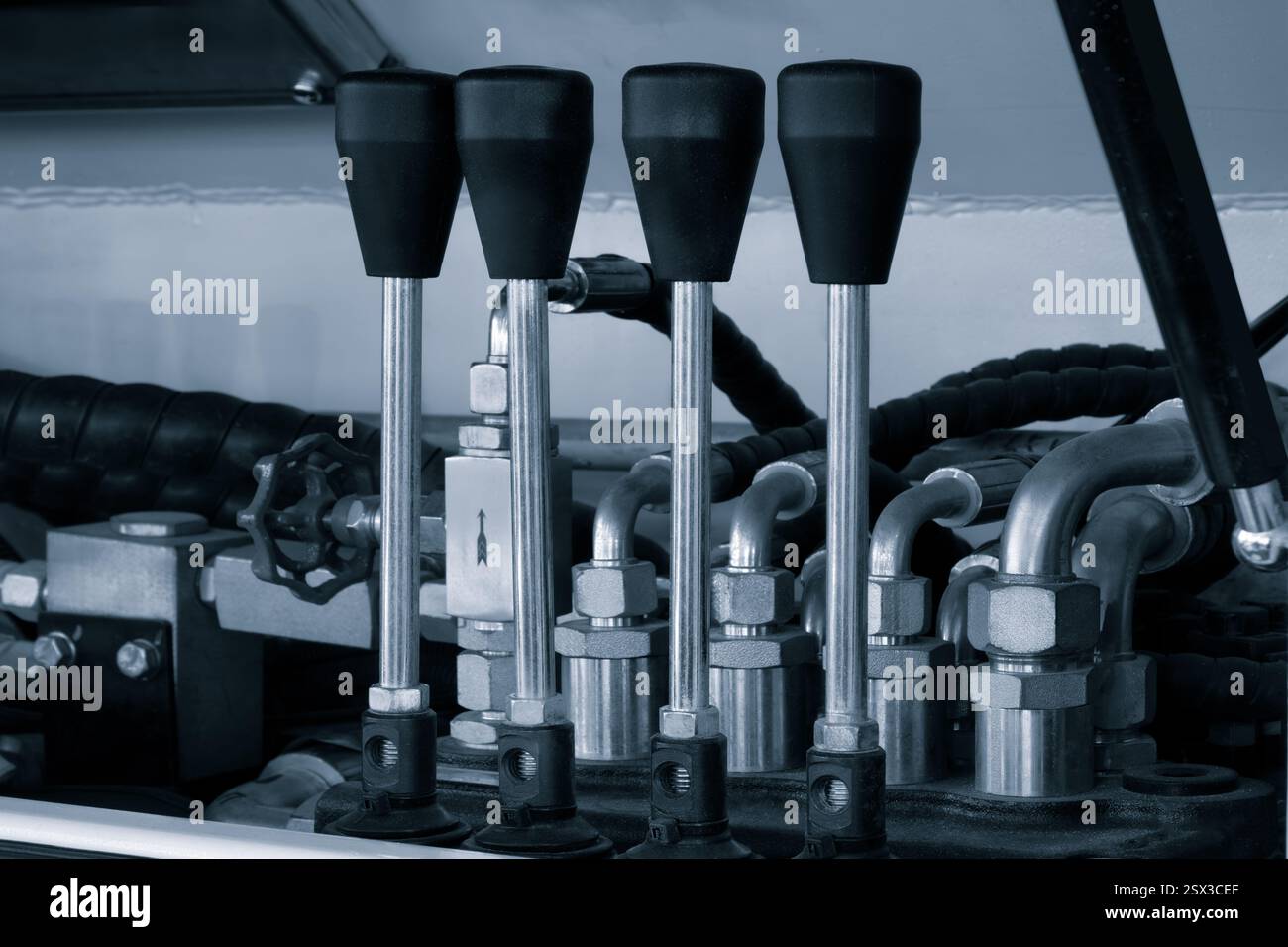 Part of a hydraulic industrial machine, control levers of a hydraulic ...