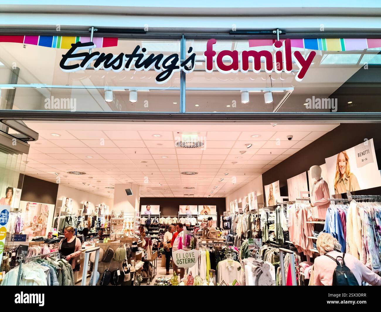 Kiel, 21. February 2025: Customers browsing and buying clothing inside ...