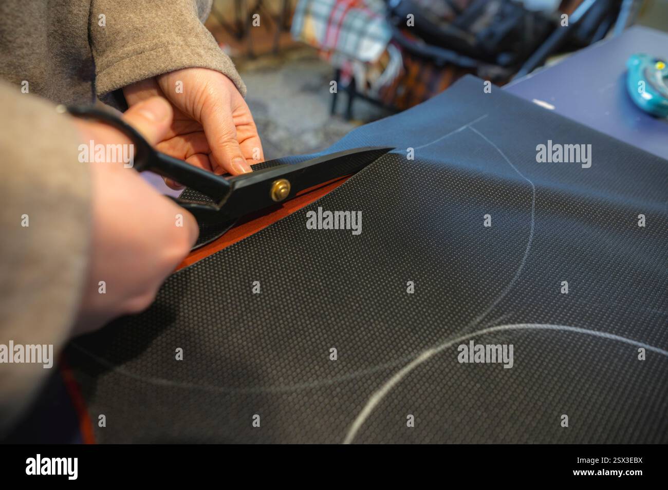 Handmade tailoring workshop, the process of marking and cutting fabric ...