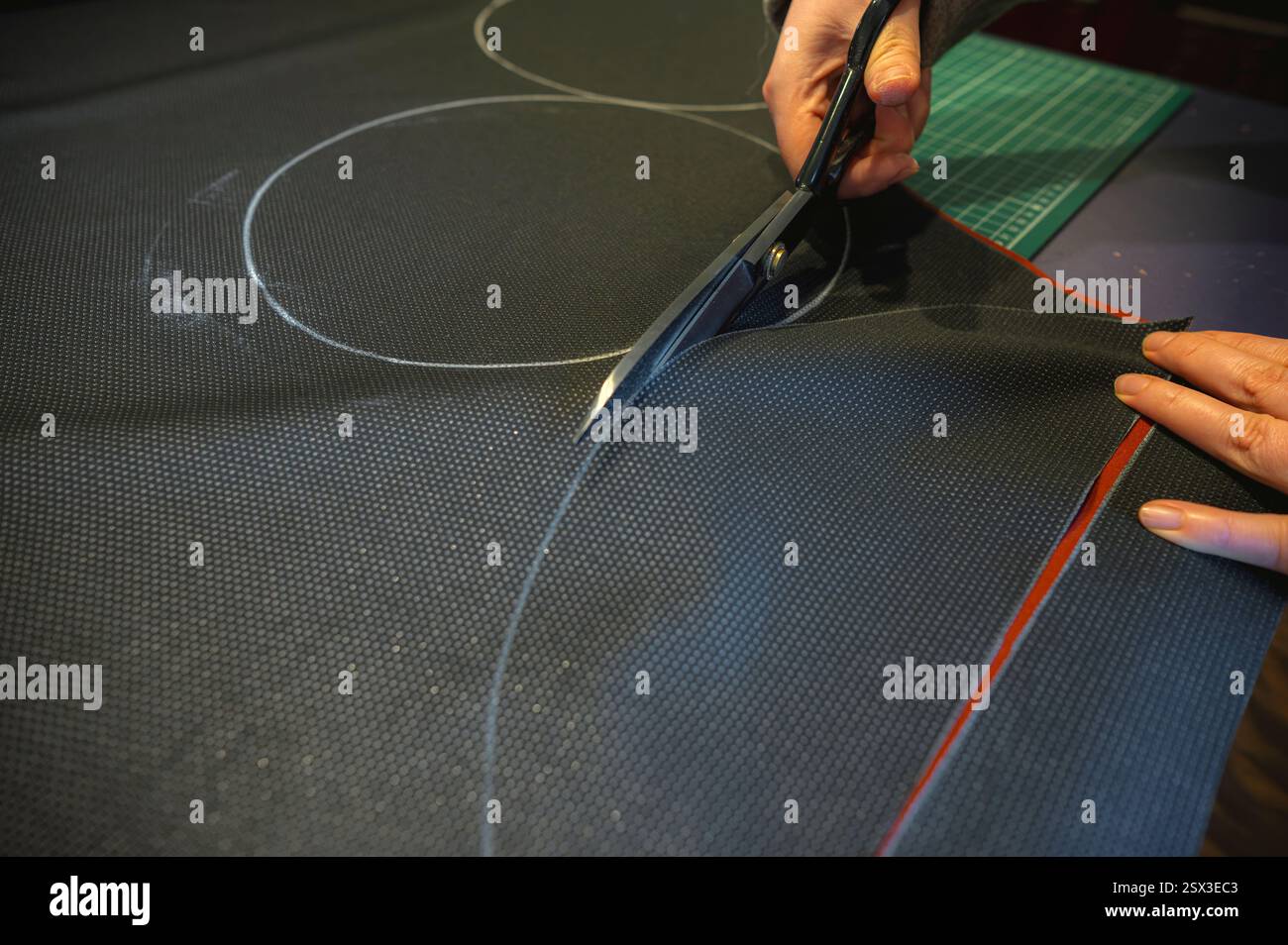 Handmade tailoring workshop, the process of marking and cutting fabric ...