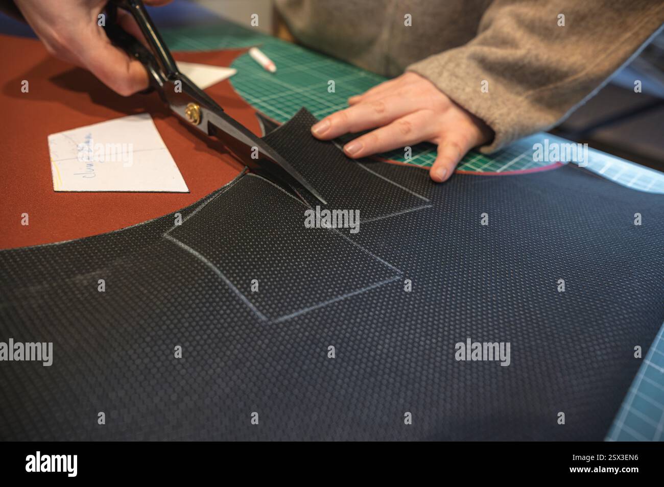 Handmade tailoring workshop, the process of marking and cutting fabric ...