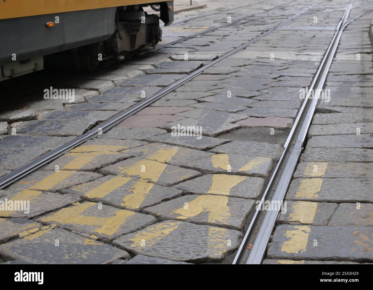 Historic pavement of Milan home to the tram tracks Stock Photo - Alamy