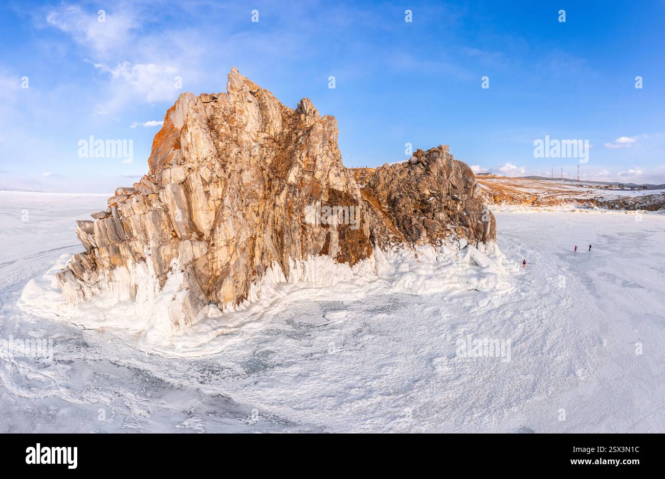 Aerial top view to famous Shamanka rock and small sea covered with snow ...