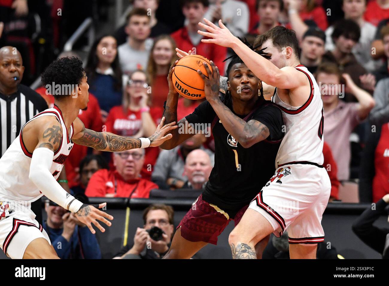 Florida State guard Jamir Watkins (1) fights his way to the basket ...