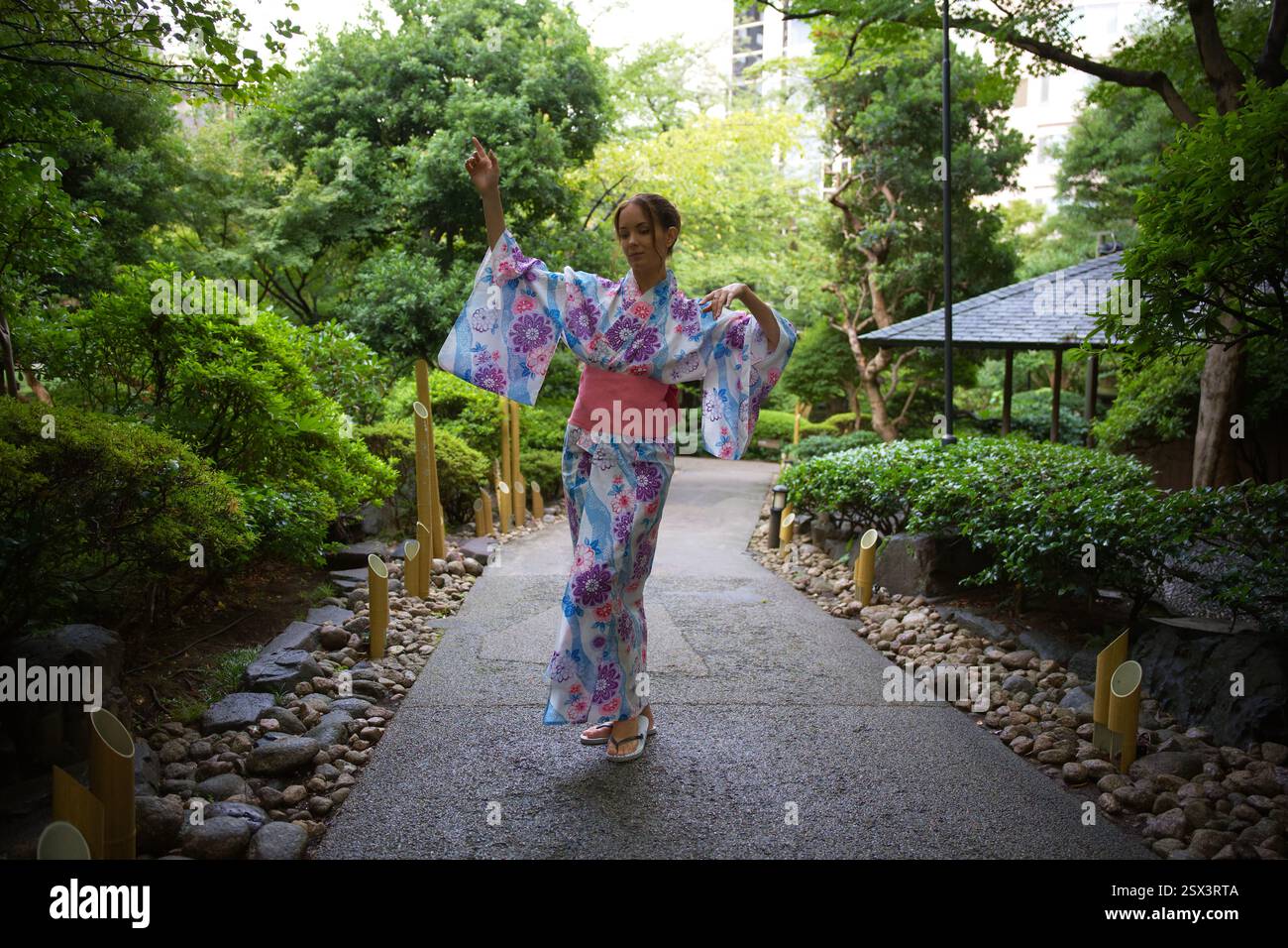 Woman Dancing in Floral Kimono in Japanese Garden Stock Photo - Alamy