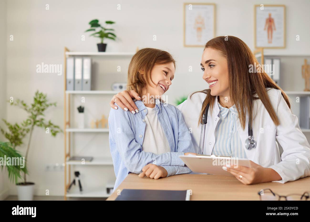 Doctor Or Nurse Embracing Boy Patient During Hospital Appointment Stock ...