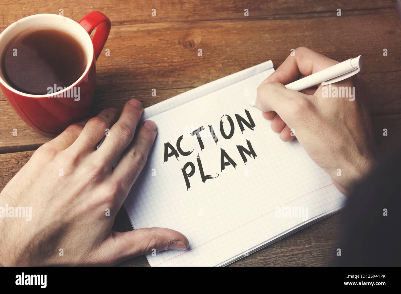 man write action plan text on notebook with coffee on desk Stock Photo ...