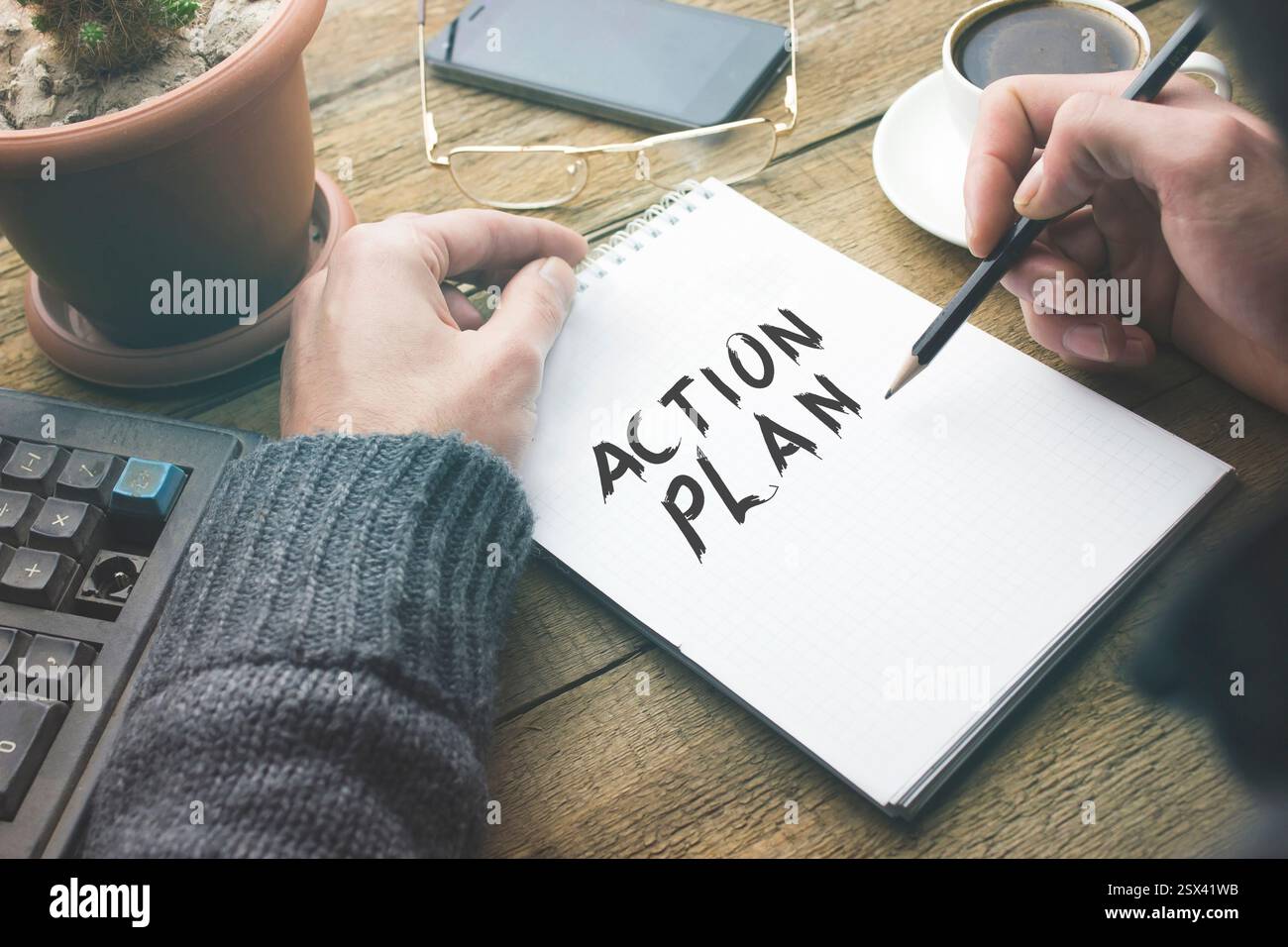 man write action plan text on notepad on working desk Stock Photo - Alamy