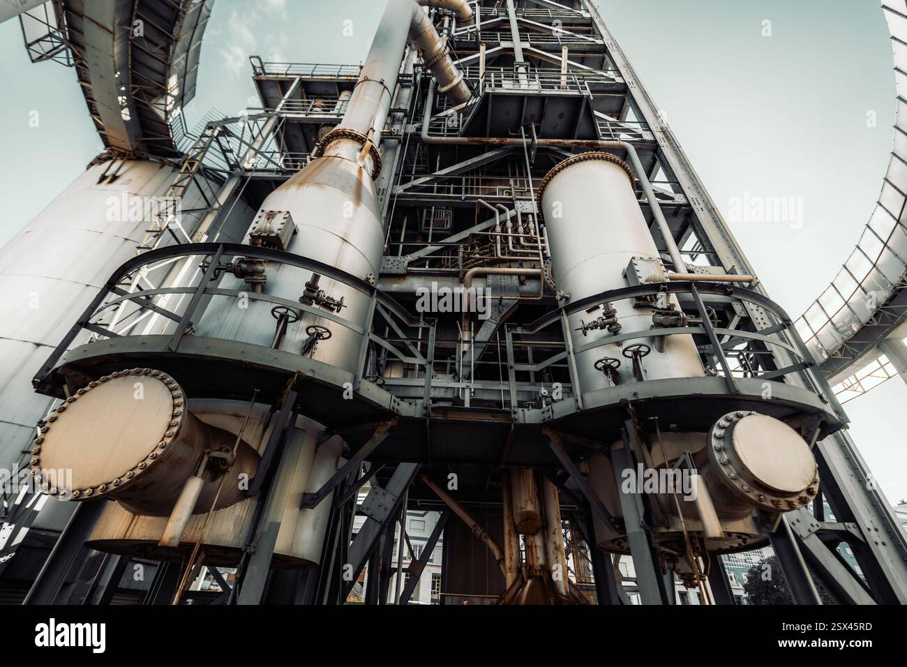 A wide-angle shot of industrial metal refinery structure with large ...